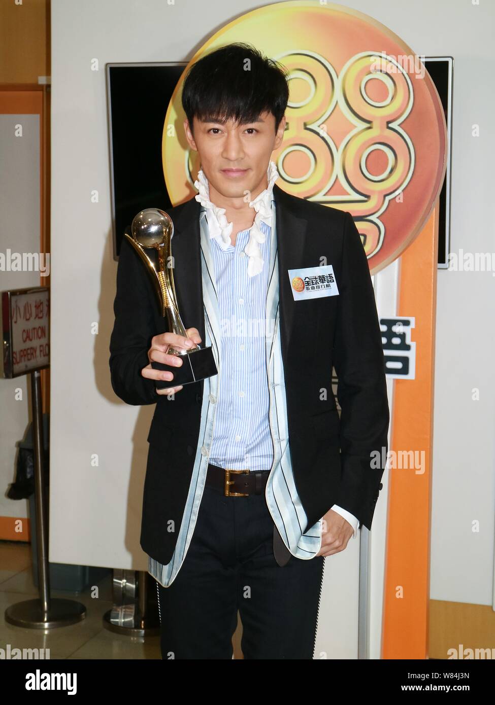 Hong Kong singer and actor Raymond Lam poses with his trophy at the ...