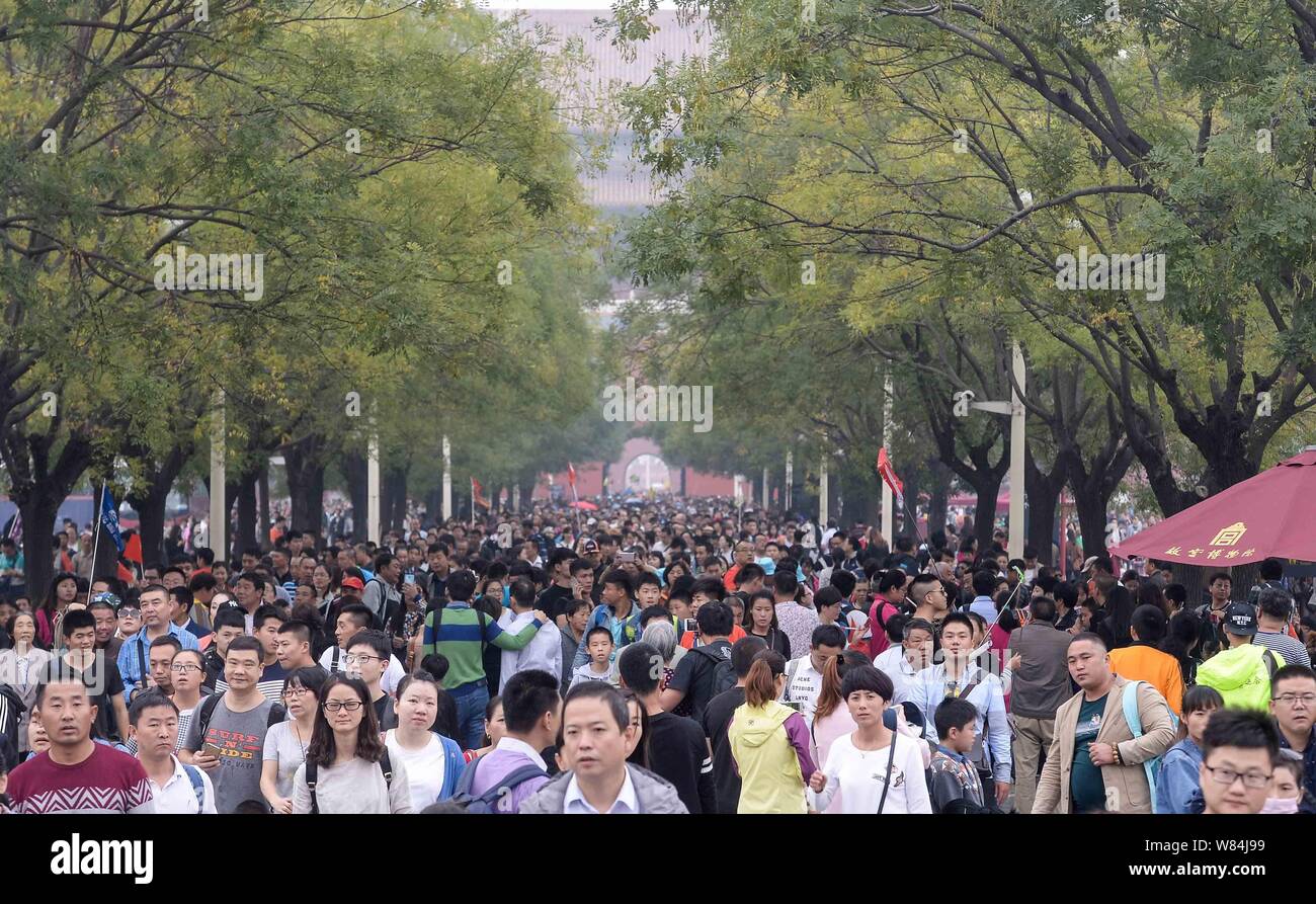 Tourists crowd the Palace Museum, also known as the Forbidden City ...