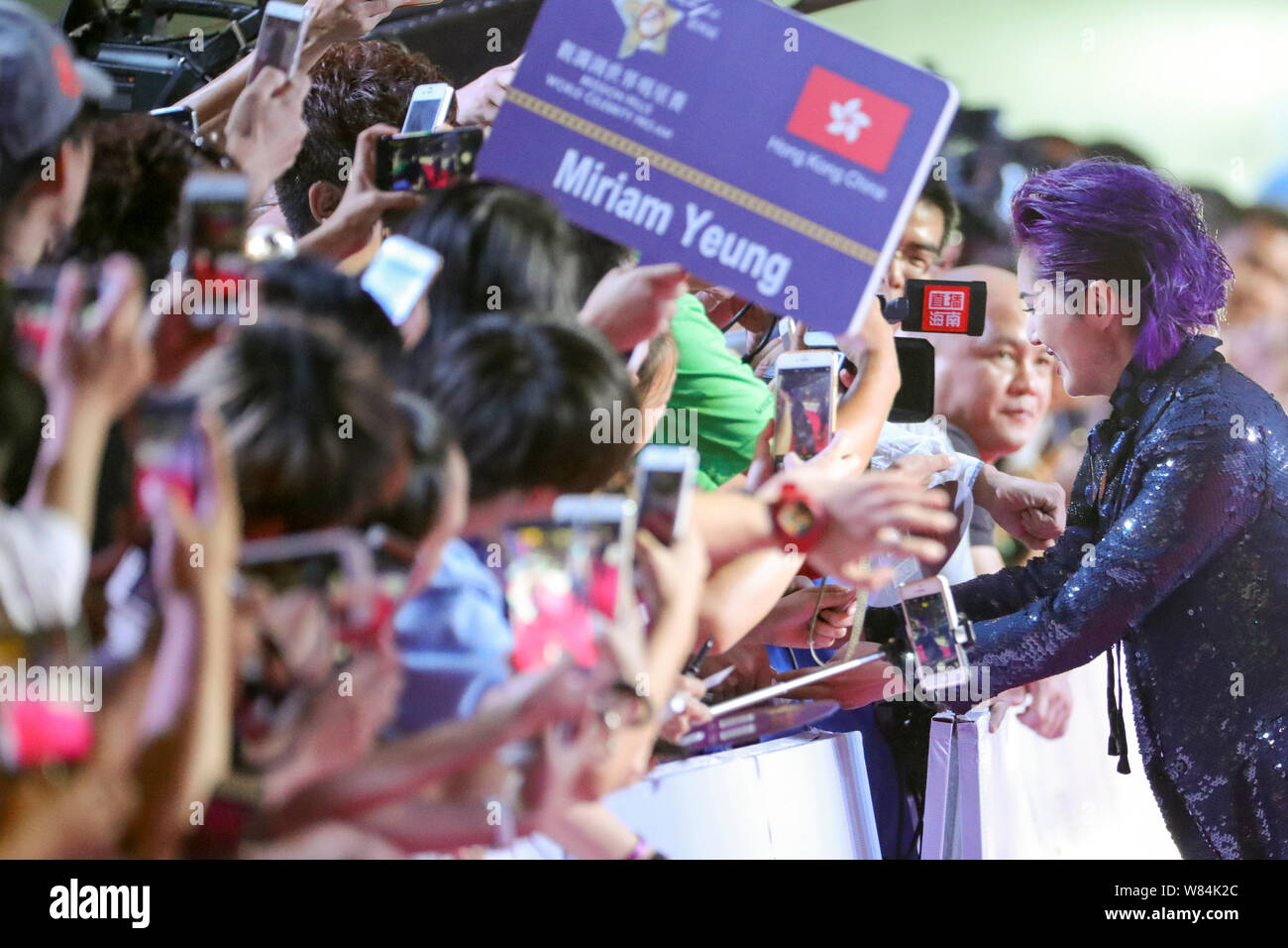Hong Kong singer and actress Miriam Yeung, right, signs autographs for ...