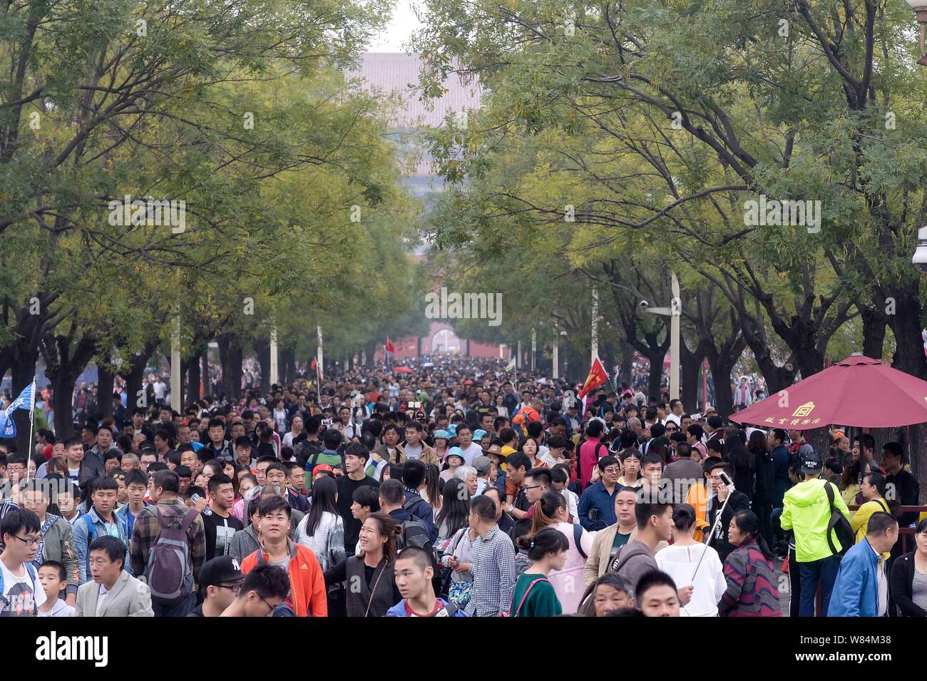Tourists crowd the Palace Museum, also known as the Forbidden City ...
