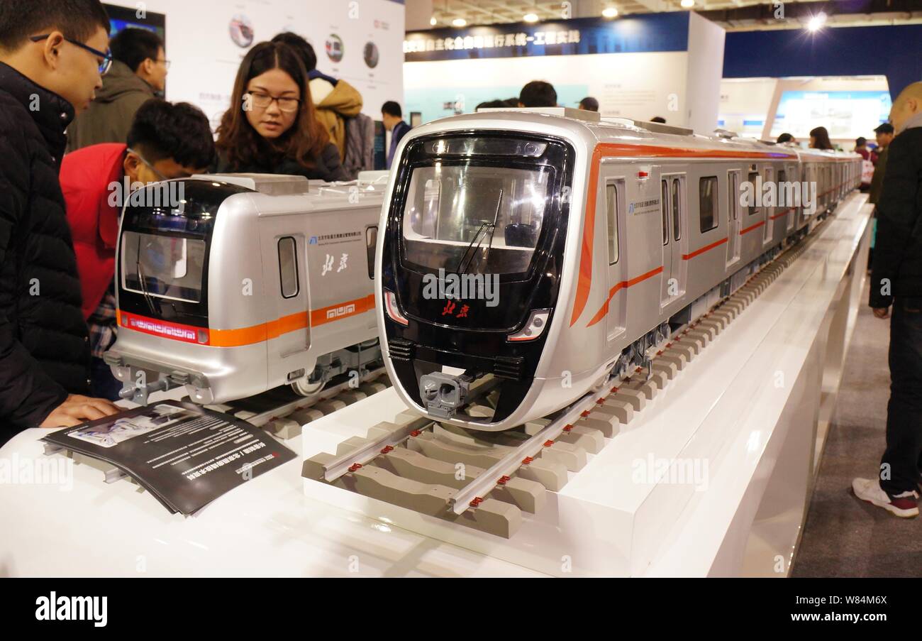 --FILE--Visitors look at model metro trains on display during the METRO ...
