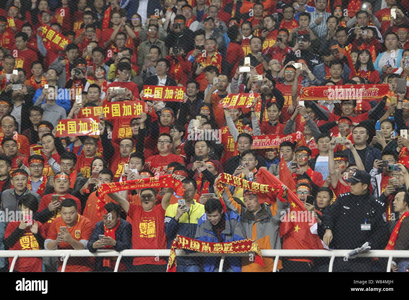 Chinese football fans hold up banners to show support for the Chinese ...