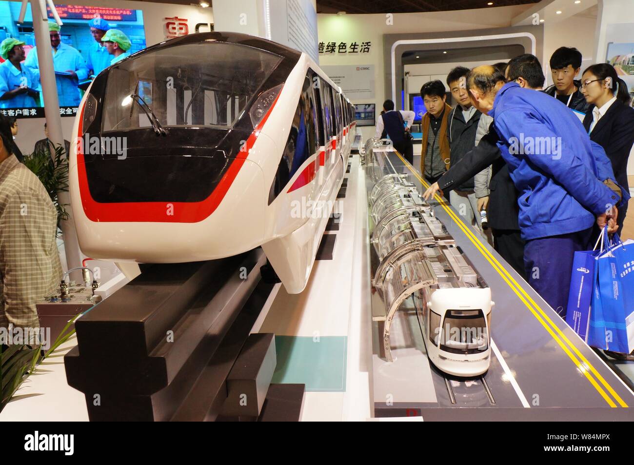 --FILE--Visitors look at model metro trains on display during the METRO ...