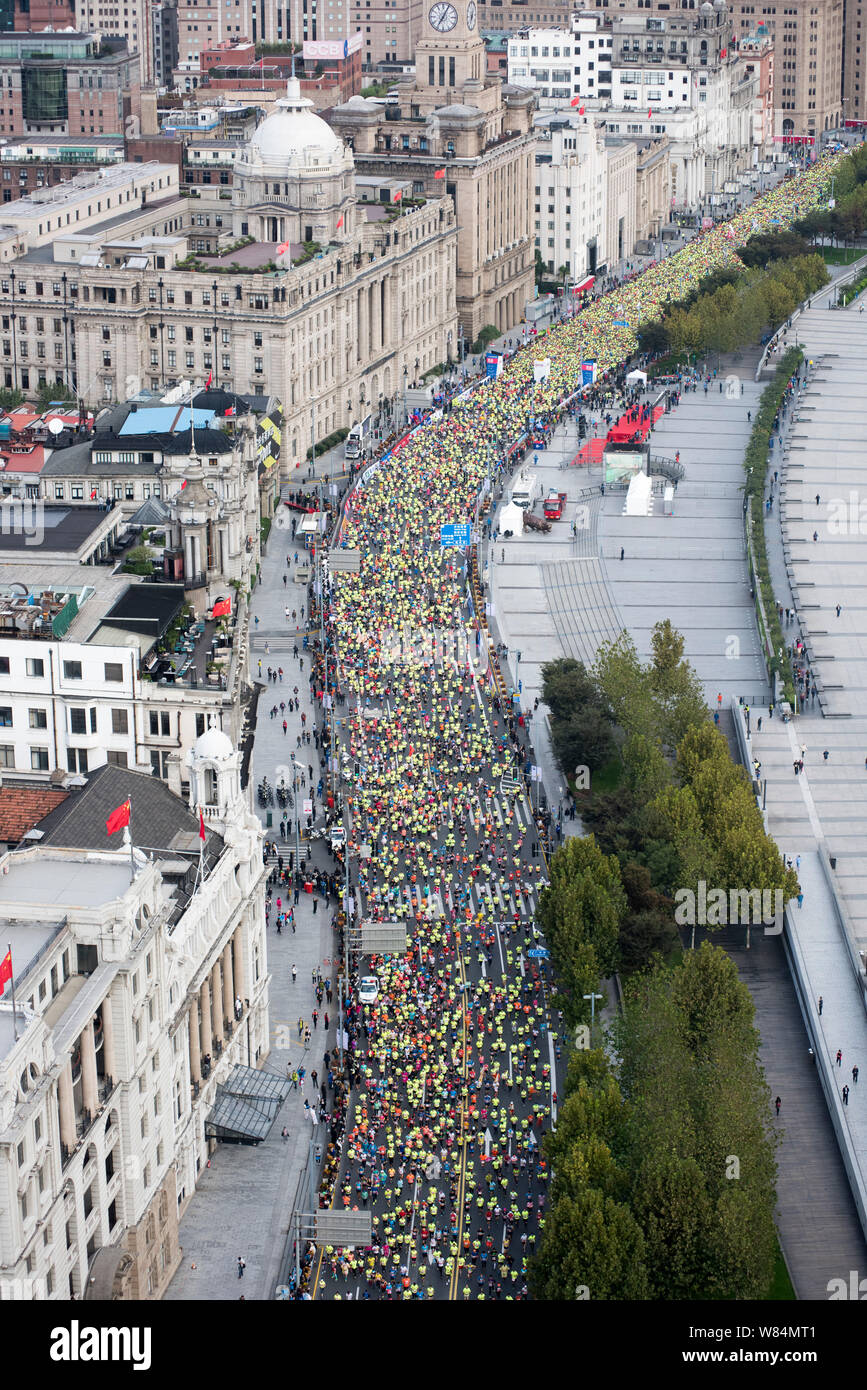 Participants run past colonial buildings along the Bund in the 2016 ...
