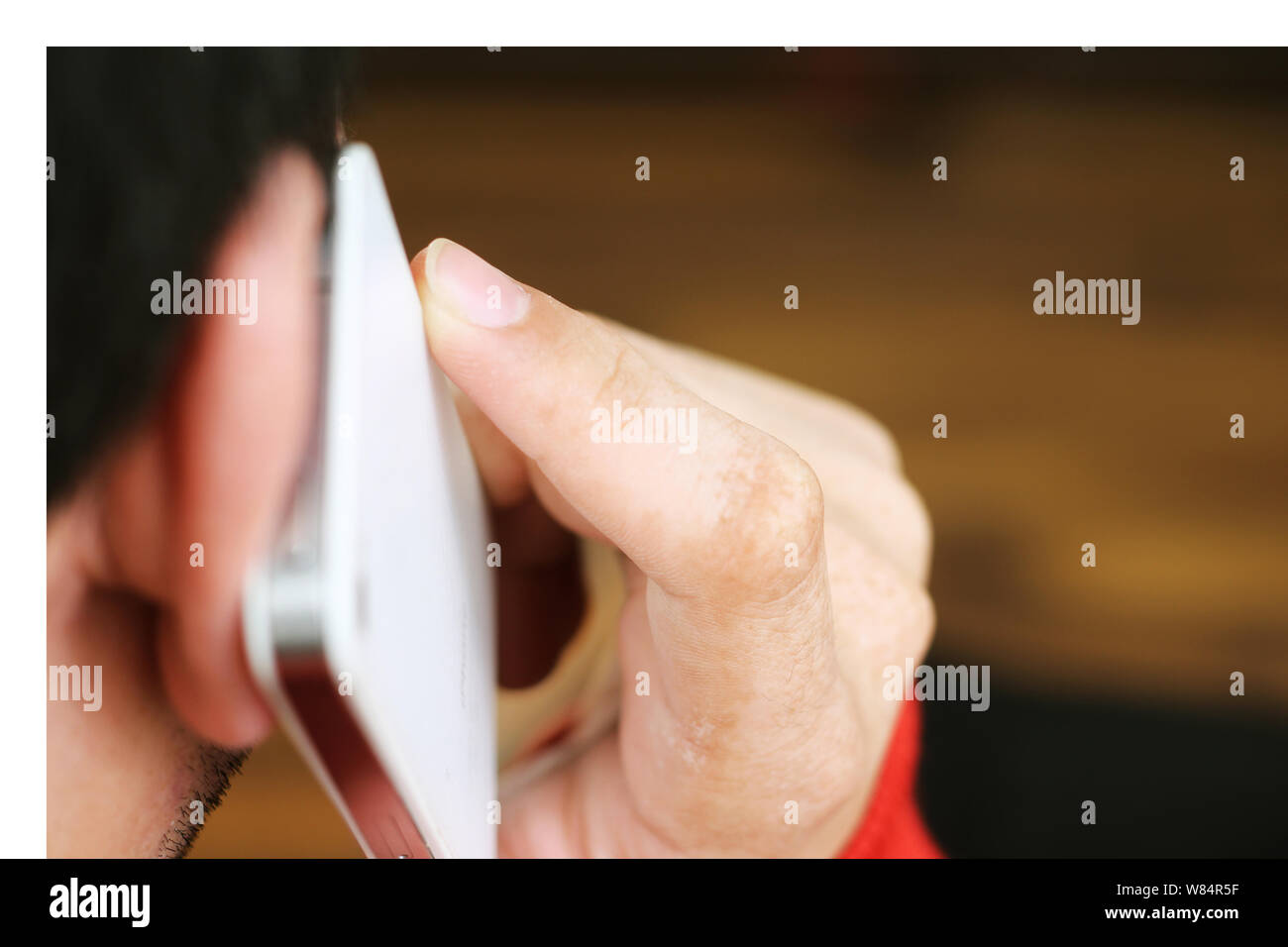 Picture of man holding a mobile in hand. Isolated on white background ...