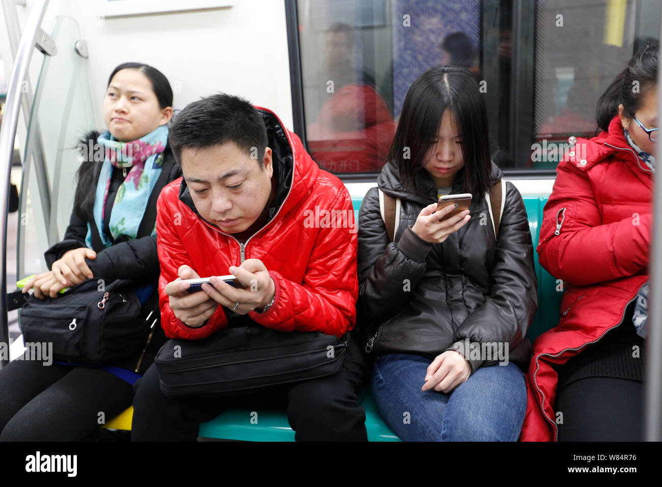 --FILE--Chinese passengers use their smartphones in a subway train in ...