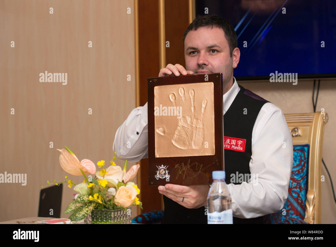 Scottish snooker player Stephen Maguire shows his handprint at an event ...