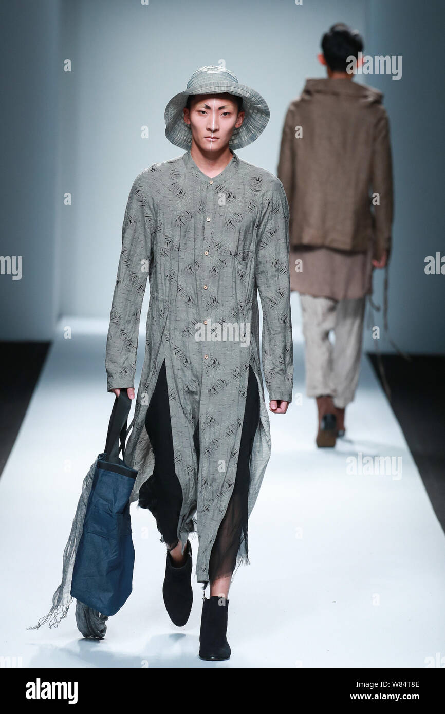 A model displays a new creation at the fashion show of Xinshen Linen ...