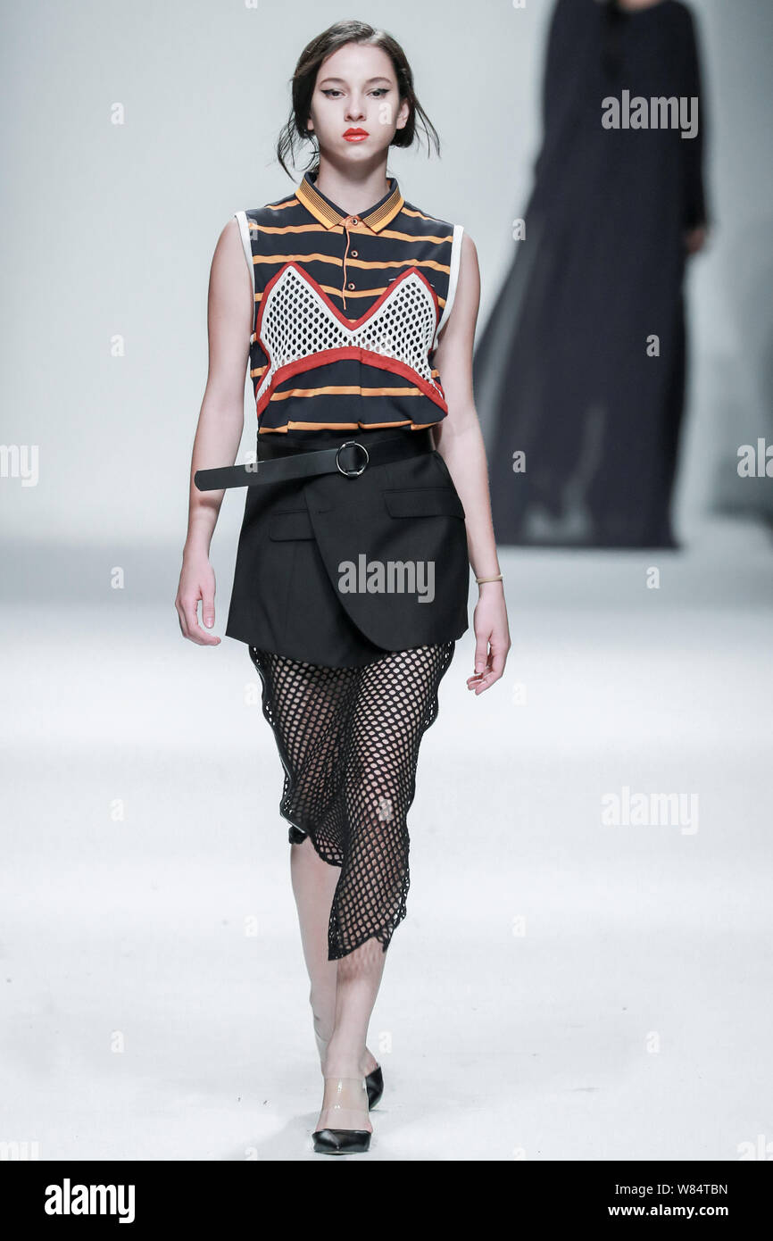 A model displays a new creation at the fashion show of Complementair during the Shanghai Fashion ...