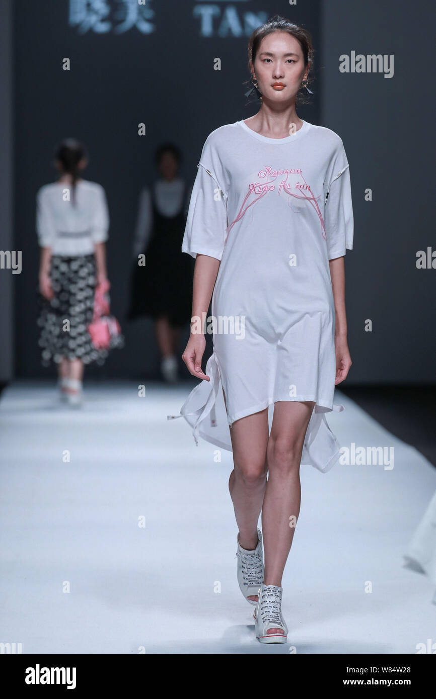 A model displays a new creation at the fashion show of Tang Xiaofu during the Shanghai Fashion ...