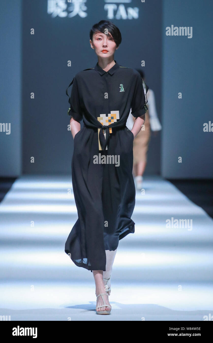 A model displays a new creation at the fashion show of Tang Xiaofu ...