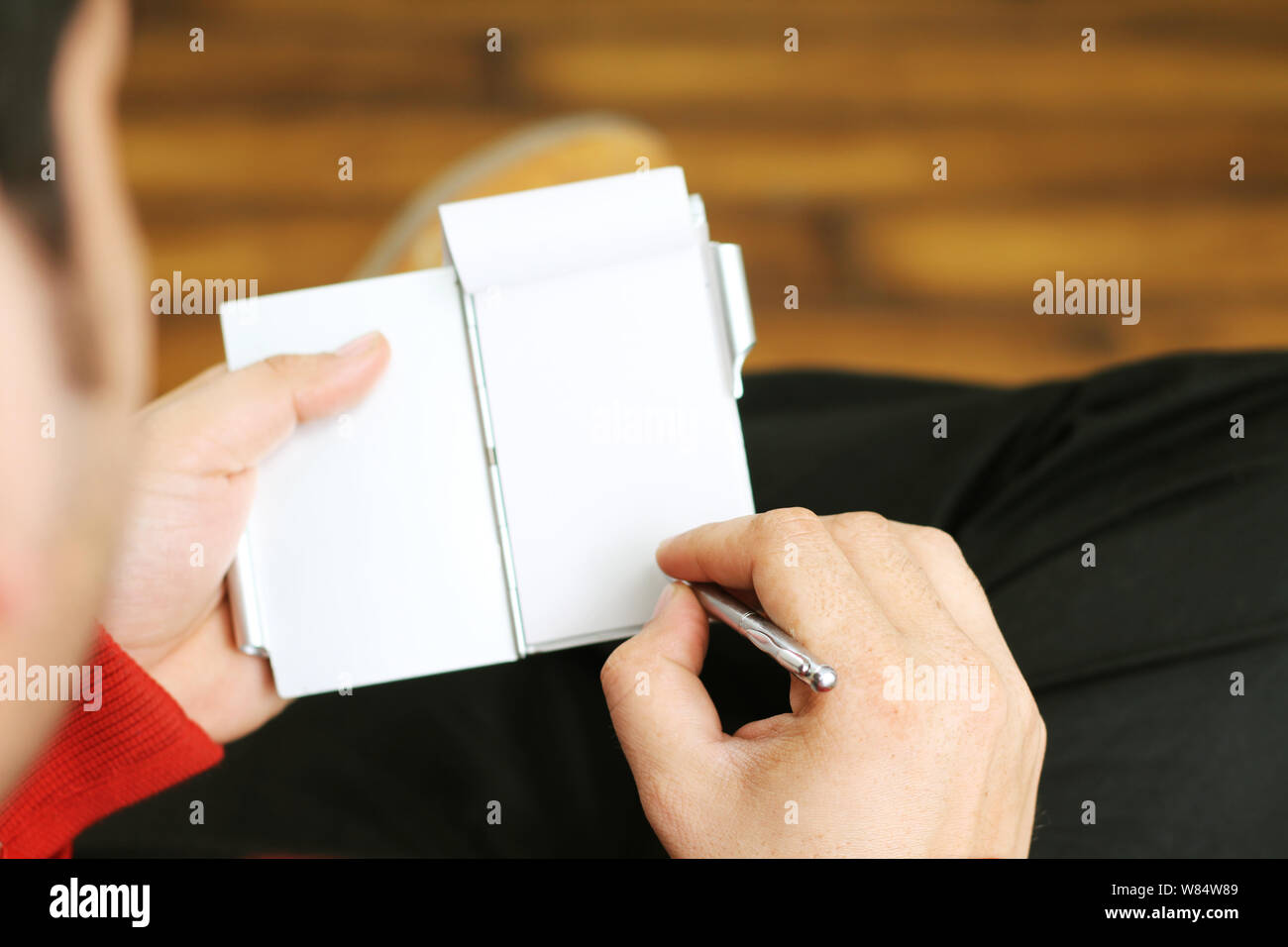 Picture of man holding a notebook in hand. Isolated on white background ...