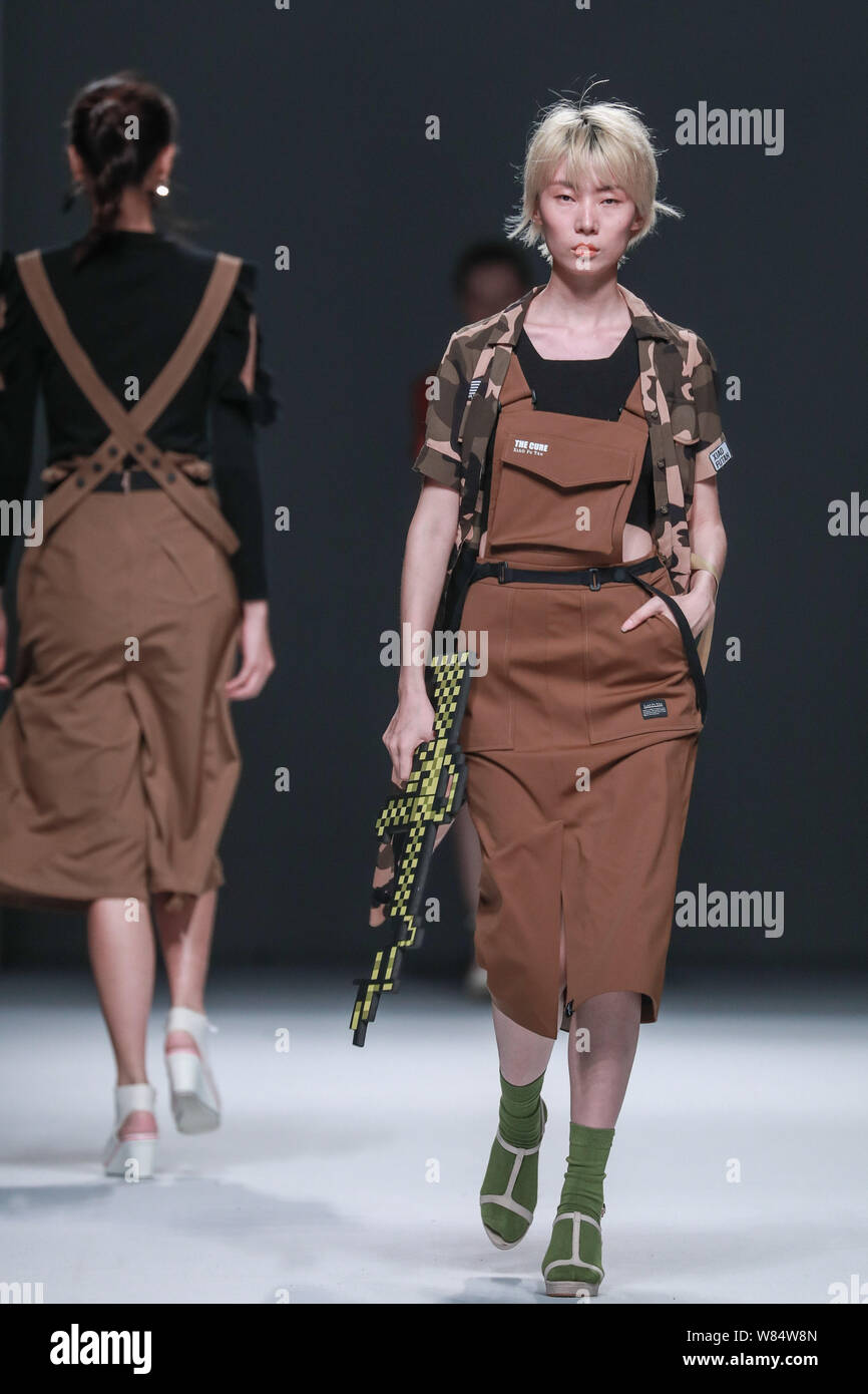A model displays a new creation at the fashion show of Tang Xiaofu during the Shanghai Fashion ...