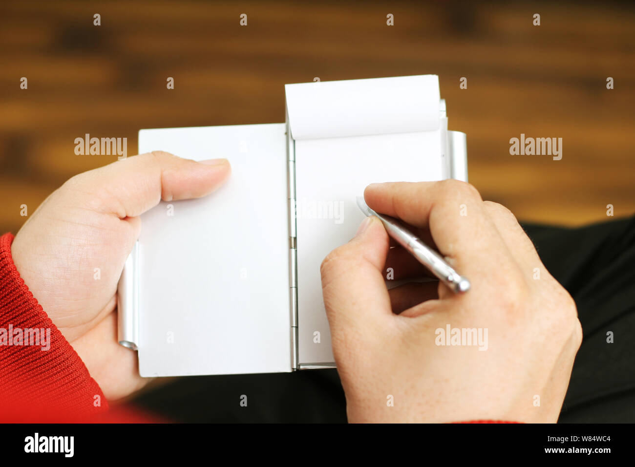 Picture of man holding a notebook in hand. Isolated on white background ...