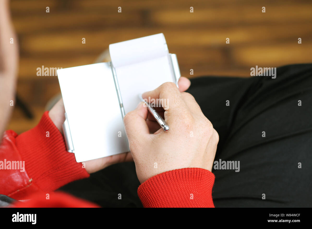 Picture of man holding a notebook in hand. Isolated on white background ...