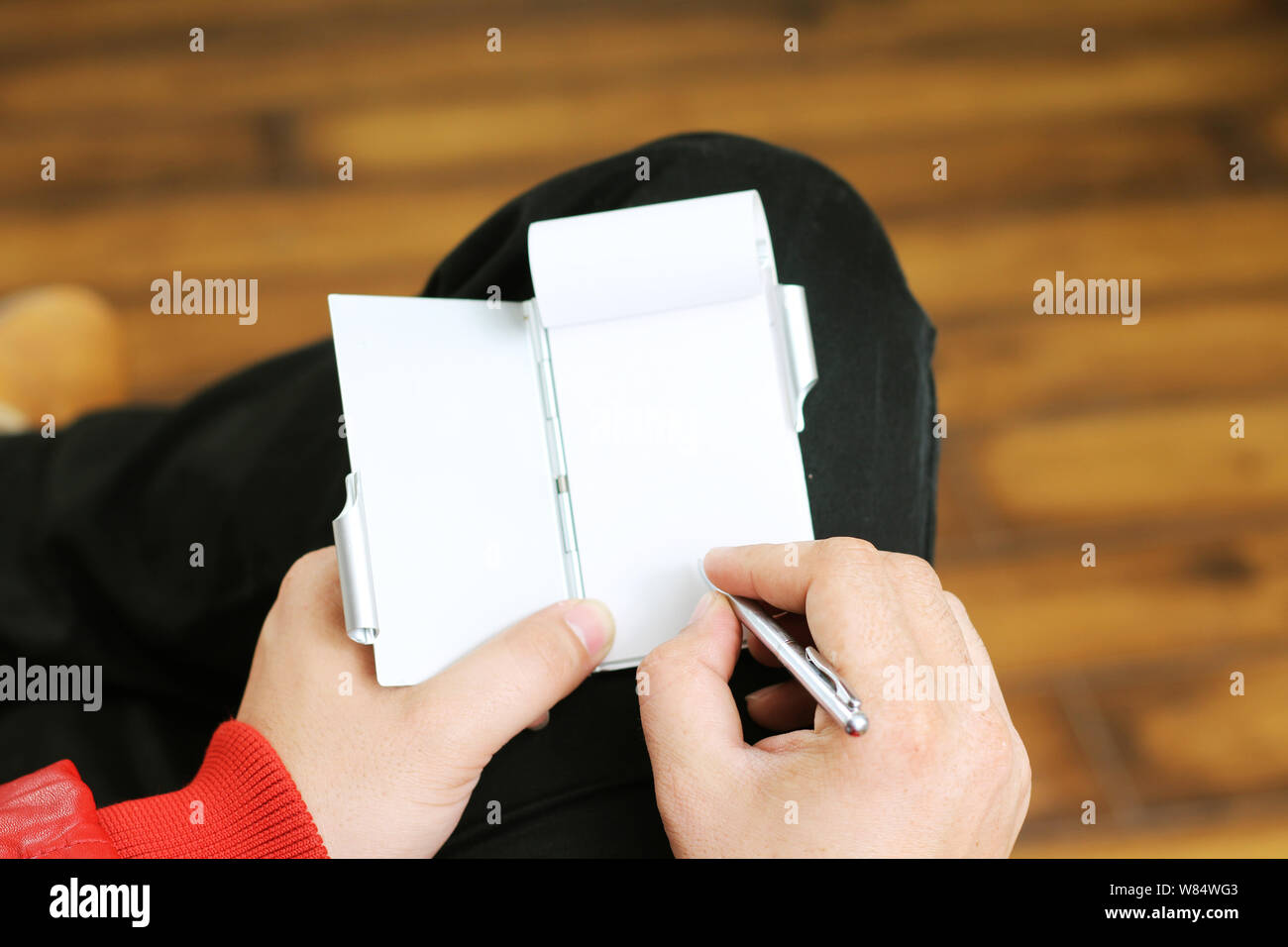 Picture of man holding a notebook in hand. Isolated on white background ...
