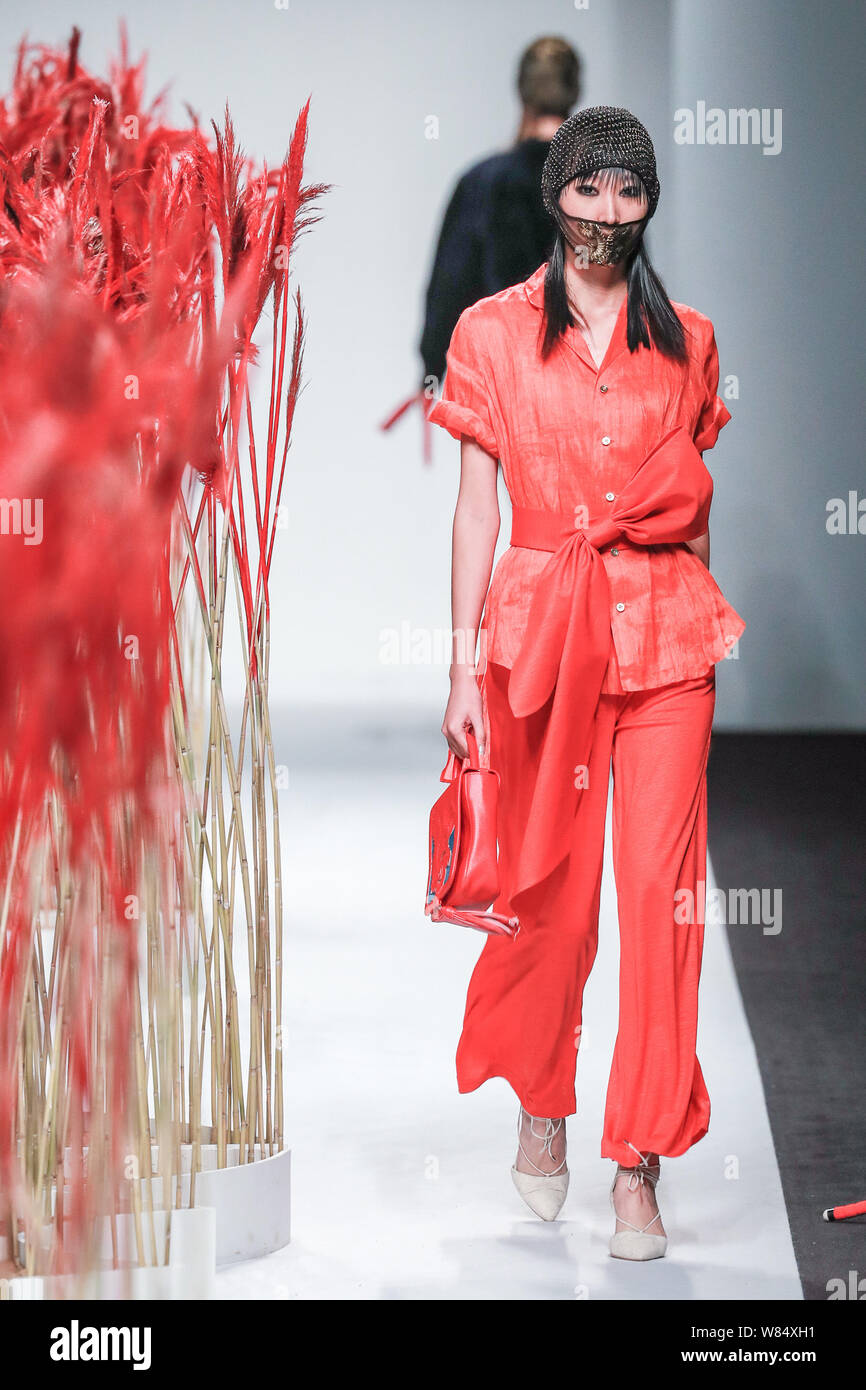 A model displays a new creation at the fashion show of Ji Cheng during ...
