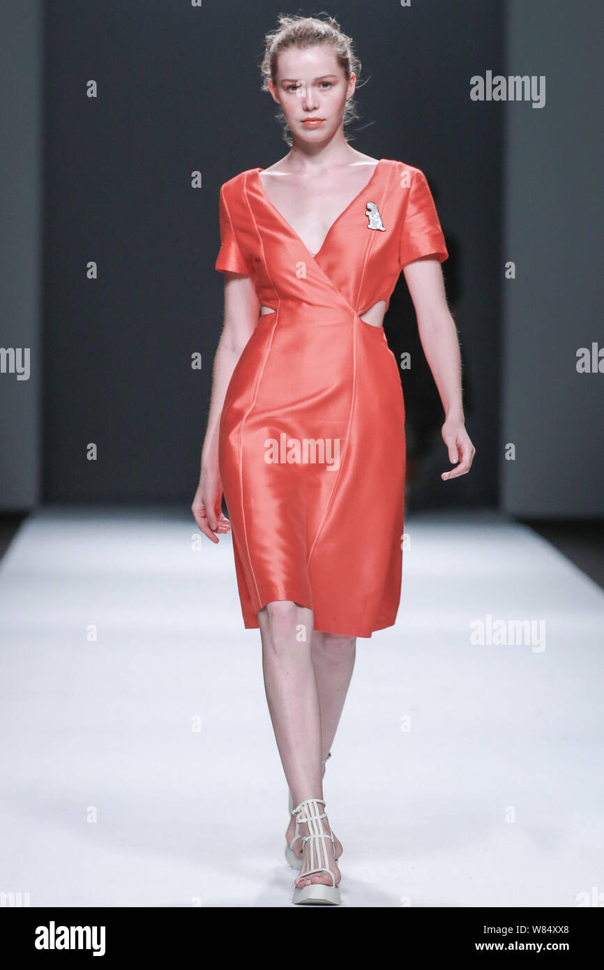A model displays a new creation at the fashion show of Tang Xiaofu during the Shanghai Fashion ...