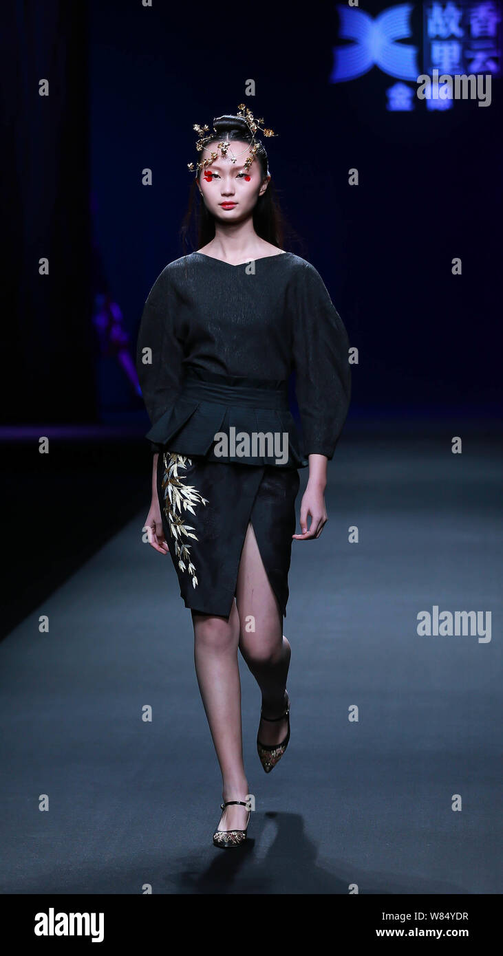 A model displays a new creation at a fashion show of Hometown of Gambiered caton Gauze by Hui ...