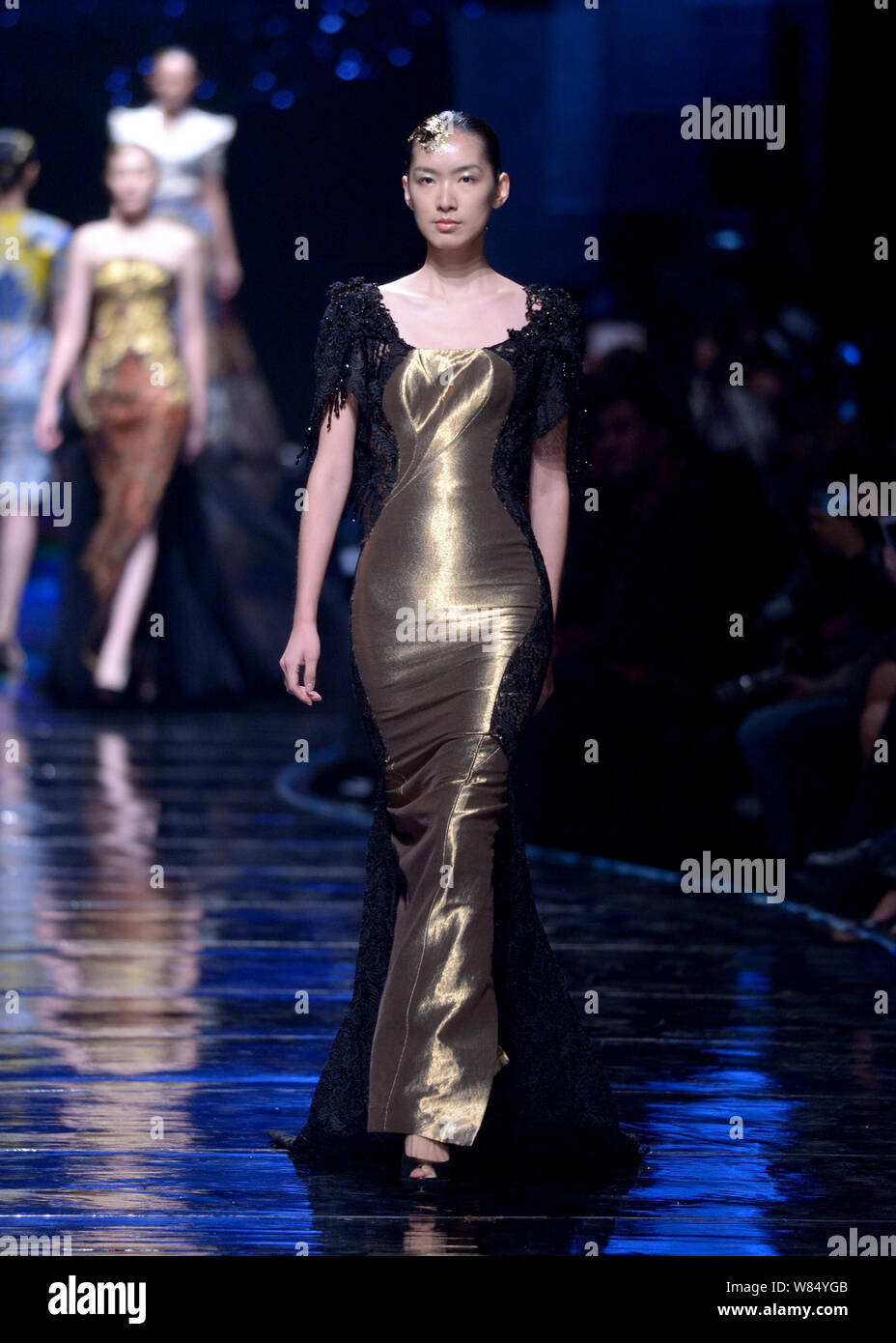 A model displays a new creation by Laurence Xu at a fashion show of ...