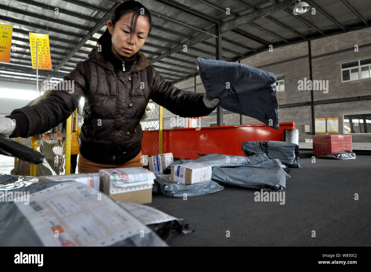 --FILE--A Chinese worker sorts parcels, most of which come from online ...