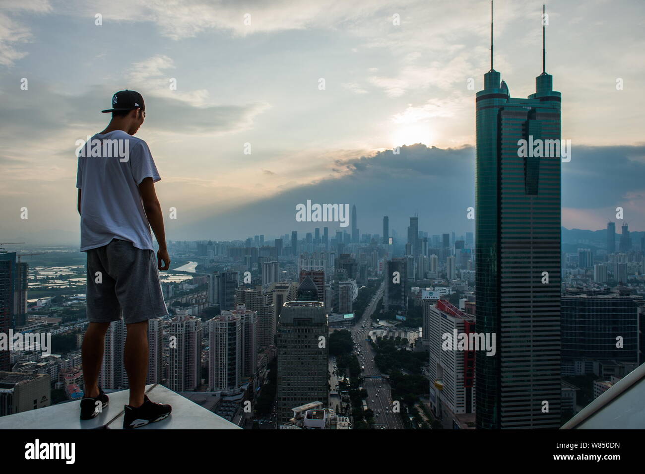 A man looks at Shun Hing Square Building, tallest, also known as Diwang ...