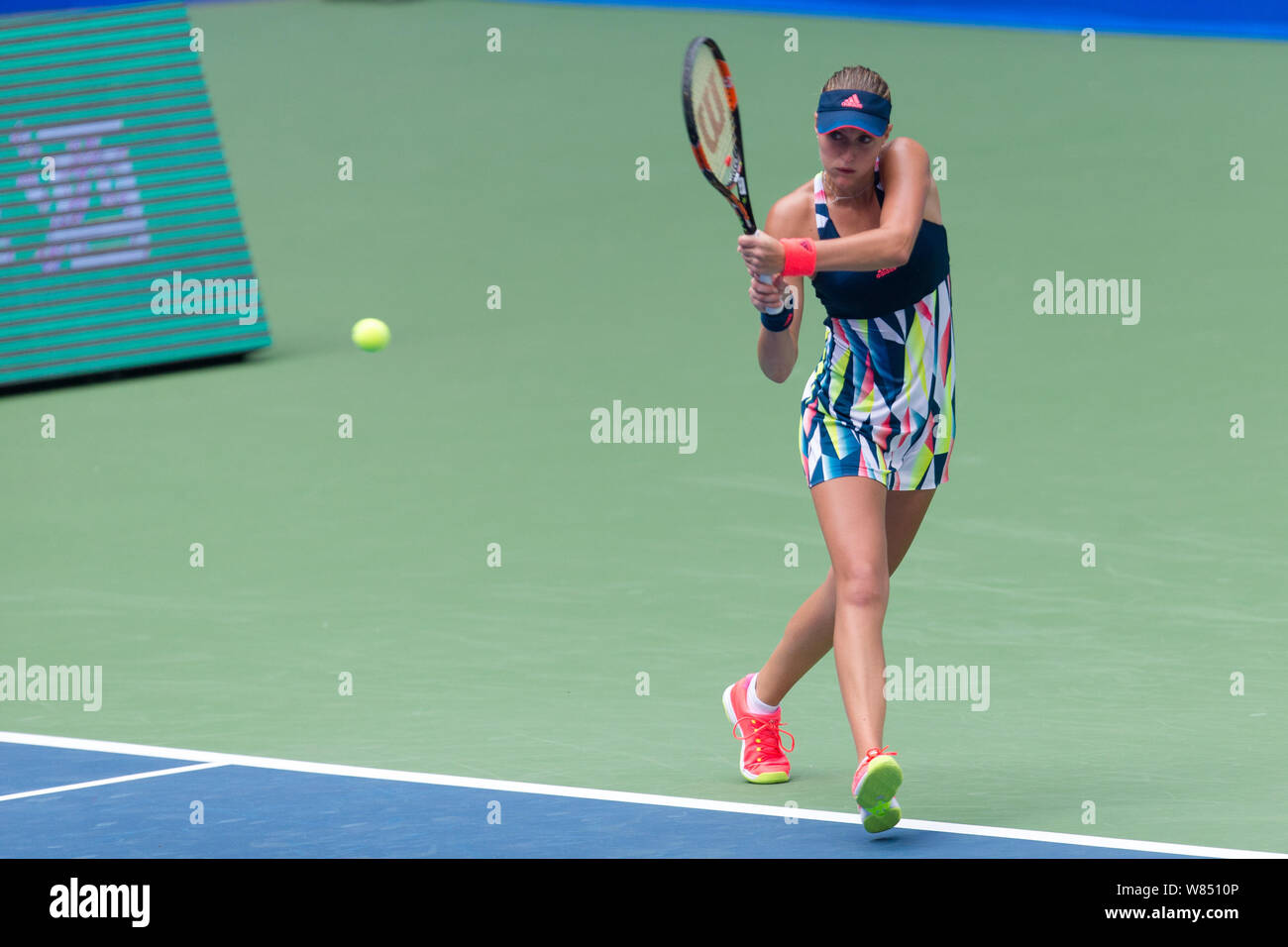 Kristina Mladenovic of France returns a shot to Angelique Kerber of ...