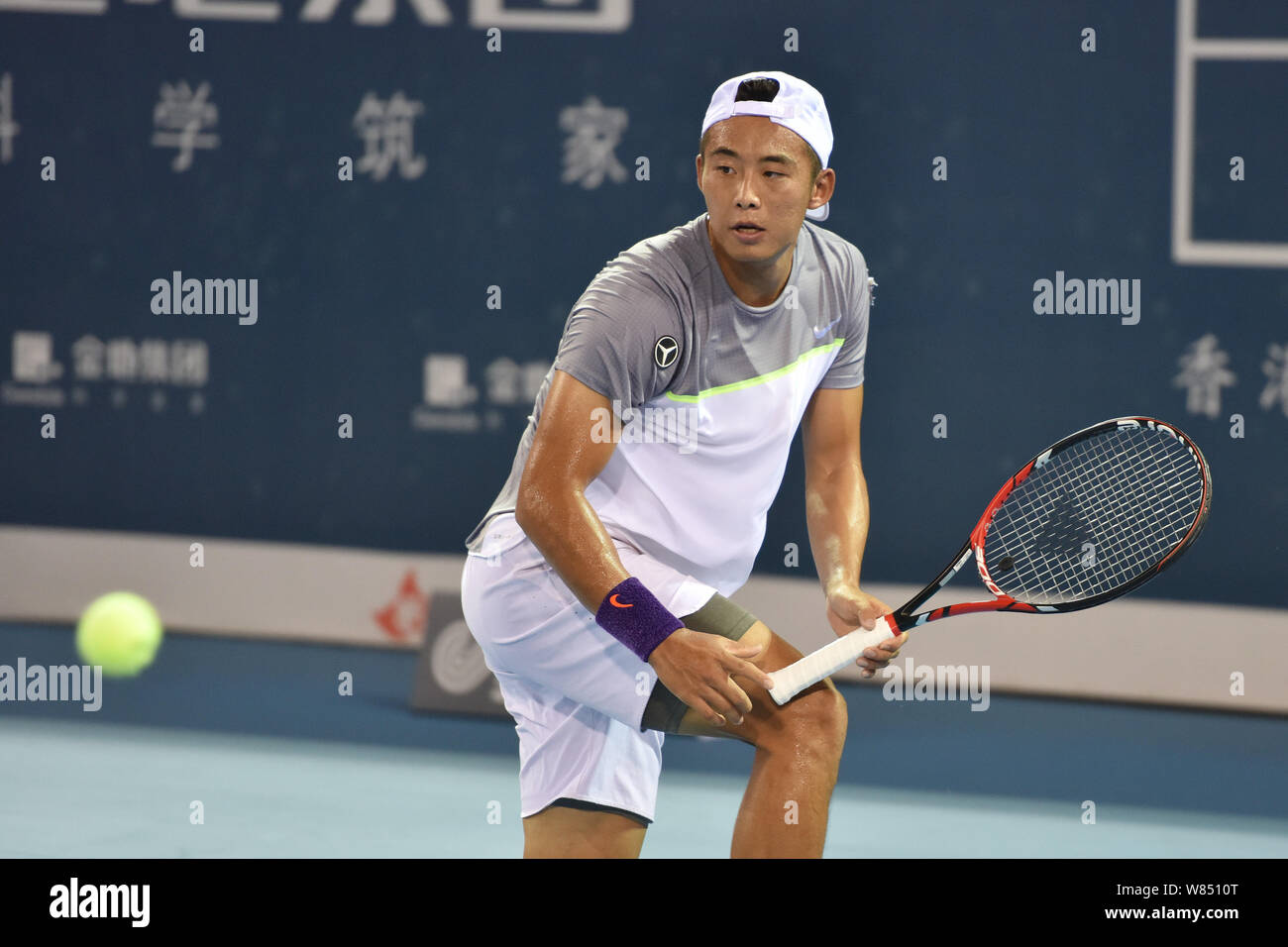 Zhang Ze of China returns a shot to Janko Tipsarevic of Serbia in their ...