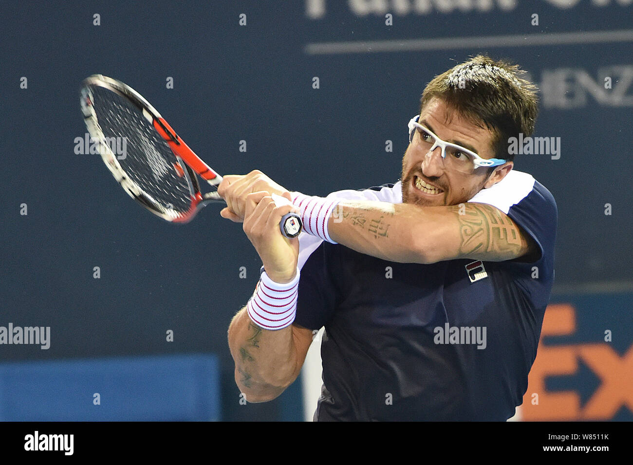 Janko Tipsarevic of Serbia returns a shot to Zhang Ze of China in their ...