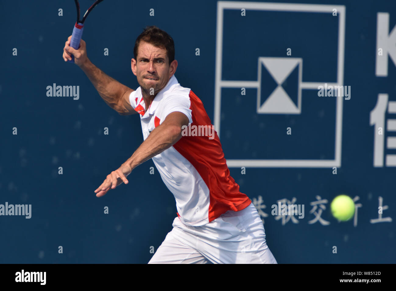 Guillermo Garcia-Lopez of Spain returns a shot to Ryan Harrison of ...