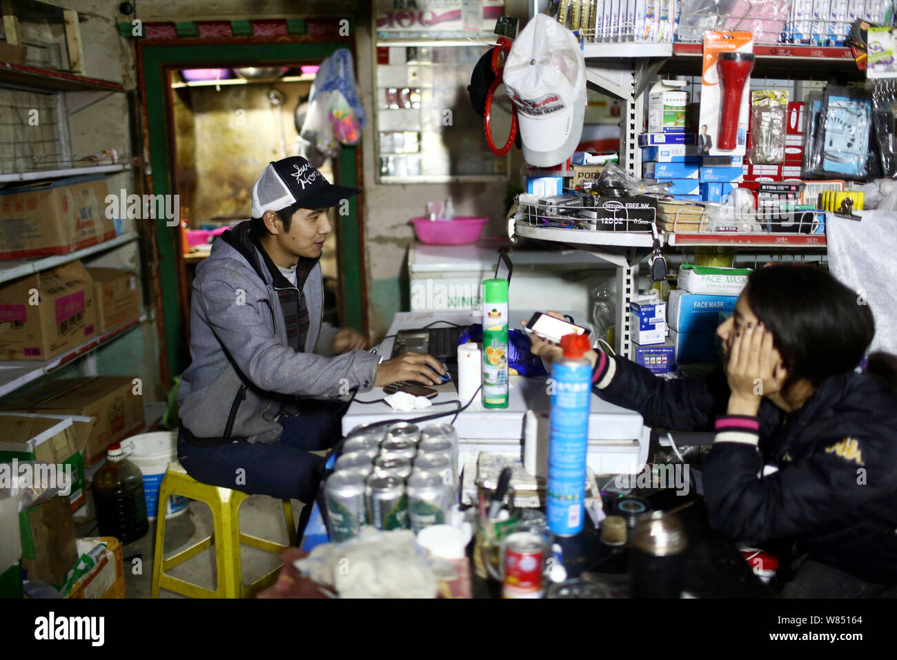 Chinese courier and station chief Yang Tao, left, learns using ...
