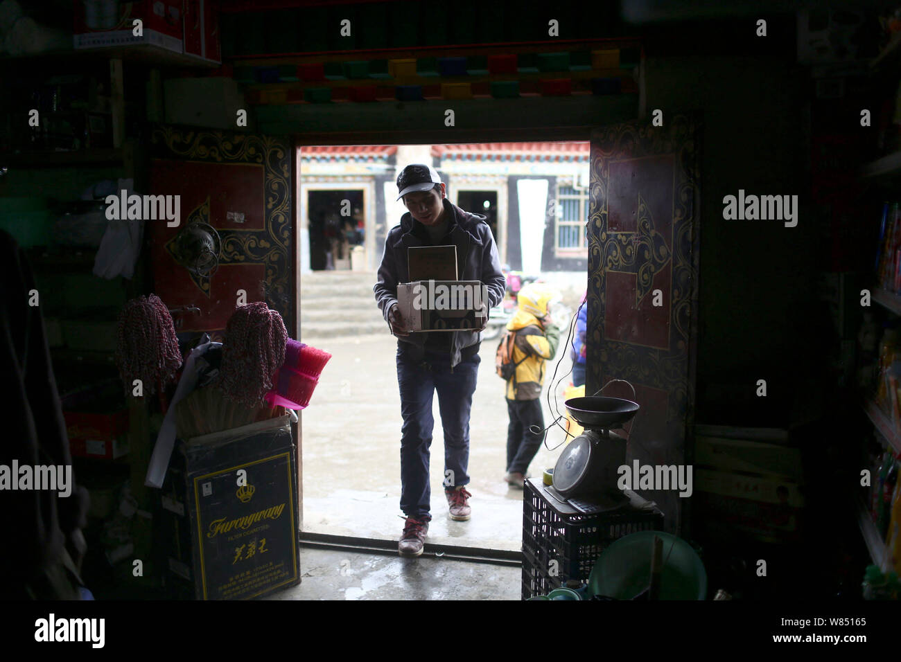 Chinese courier and station chief Yang Tao carries parcels from online ...