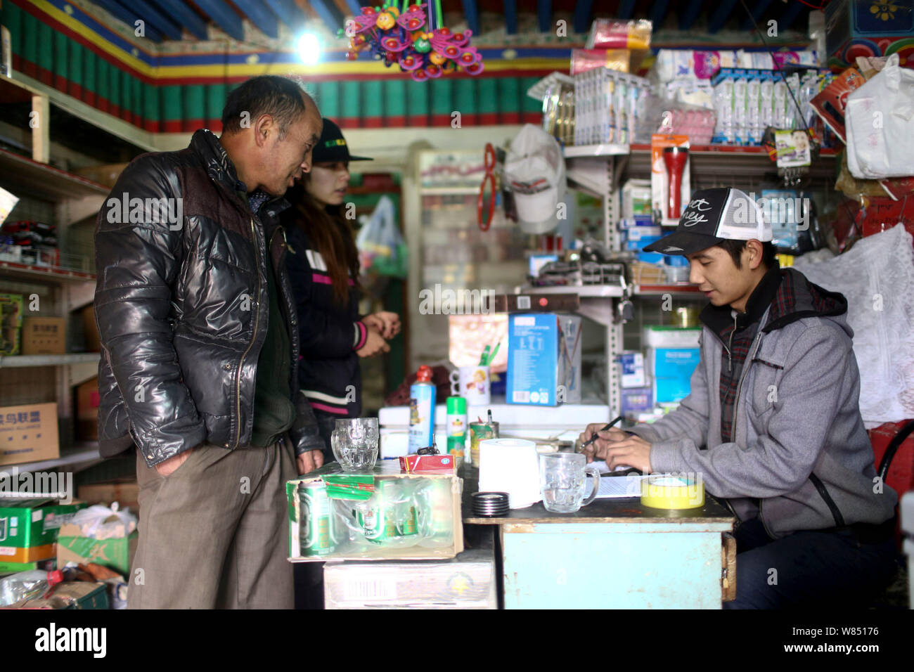 Chinese courier and station chief Yang Tao, right, serves local ...