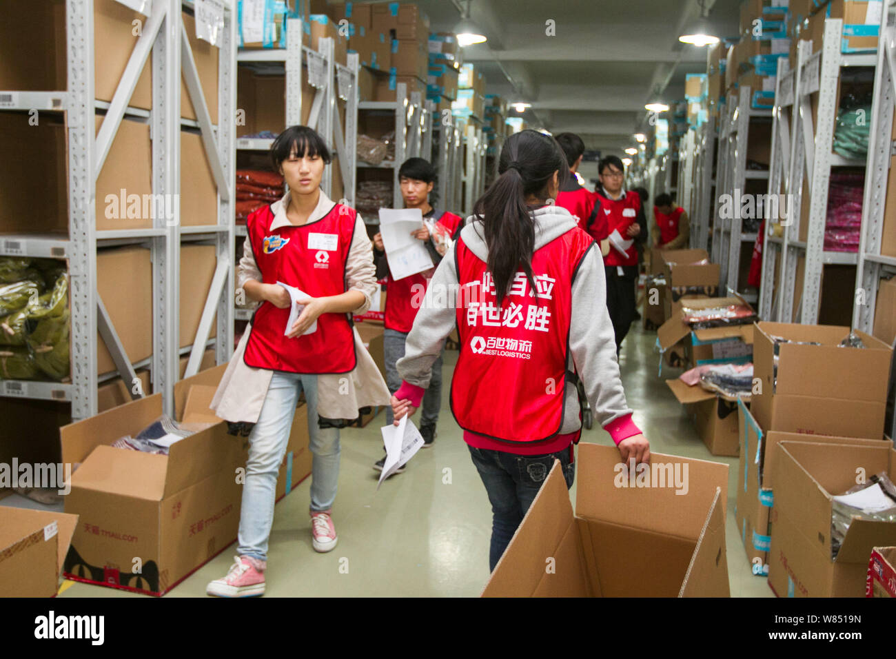 --FILE--Chinese employees package goods and sort out parcels from ...