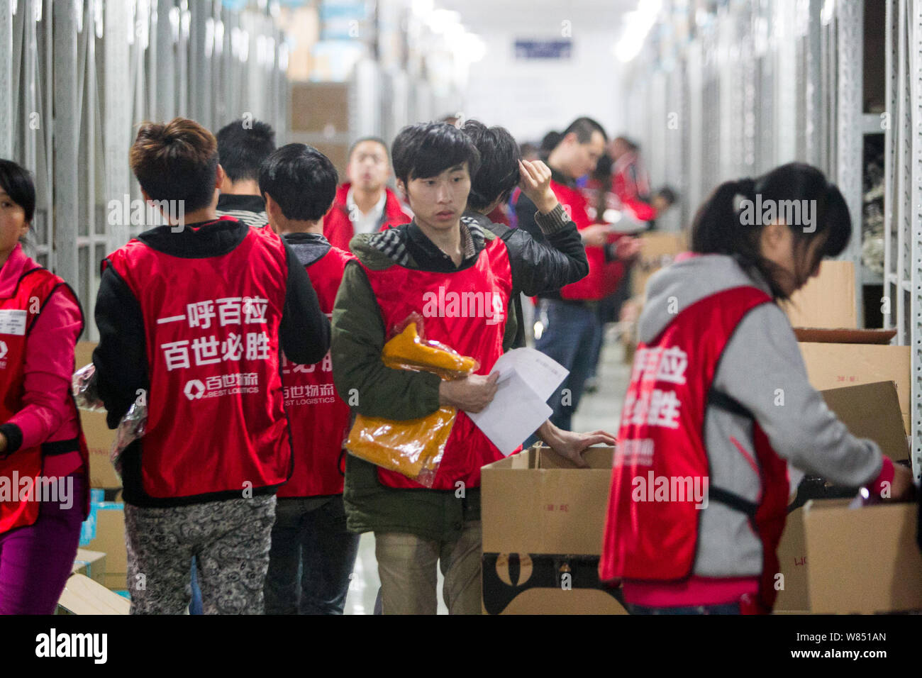 --FILE--Chinese employees package goods and sort out parcels from ...