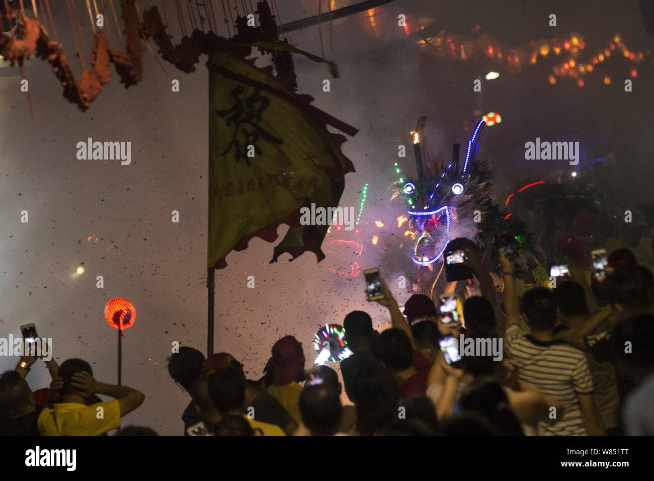 Chinese entertainers perform a fire dragon dance to celebrate the Mid ...