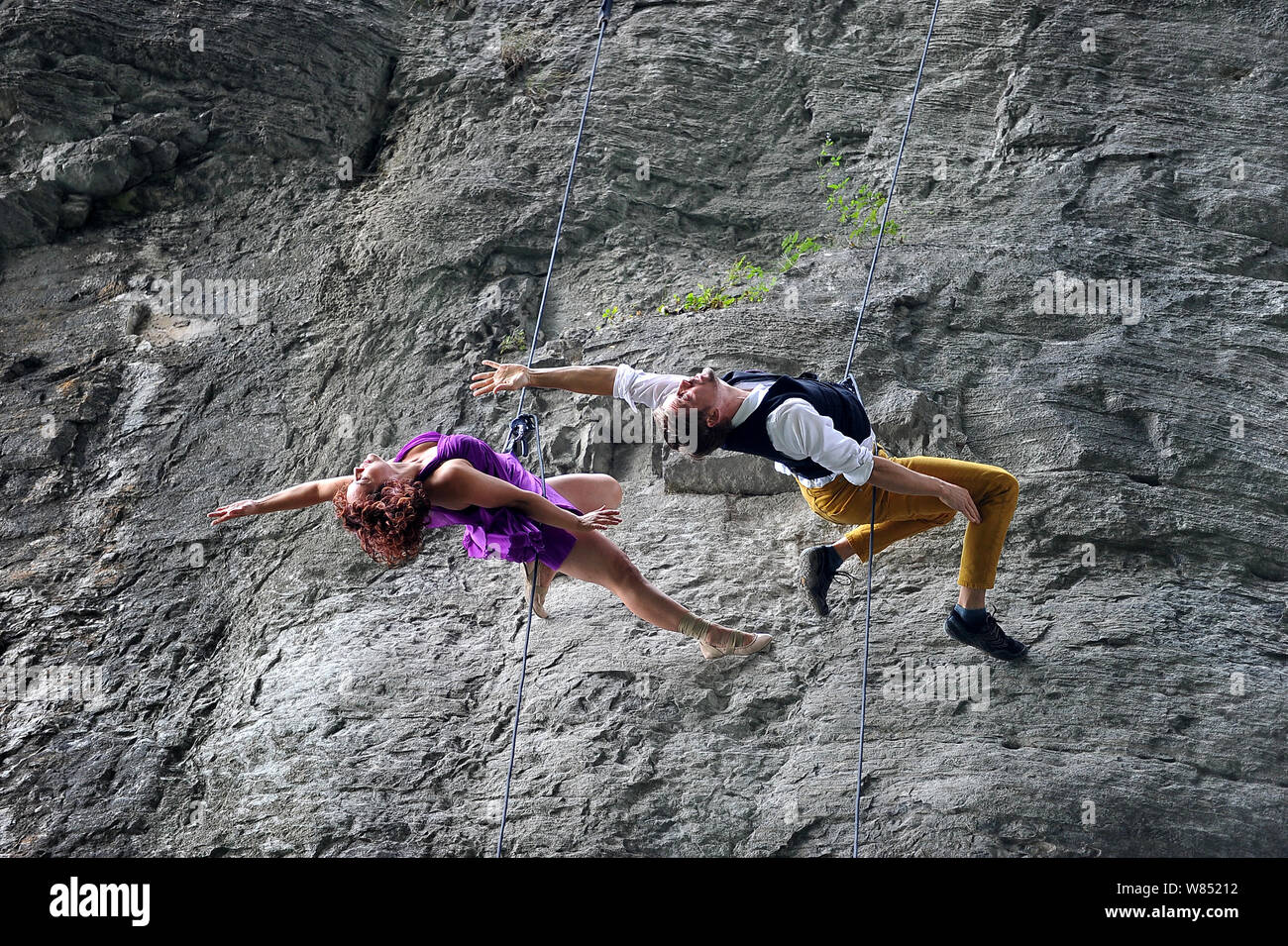 Dancers from American dance troupe Bandaloop perform as they were ...
