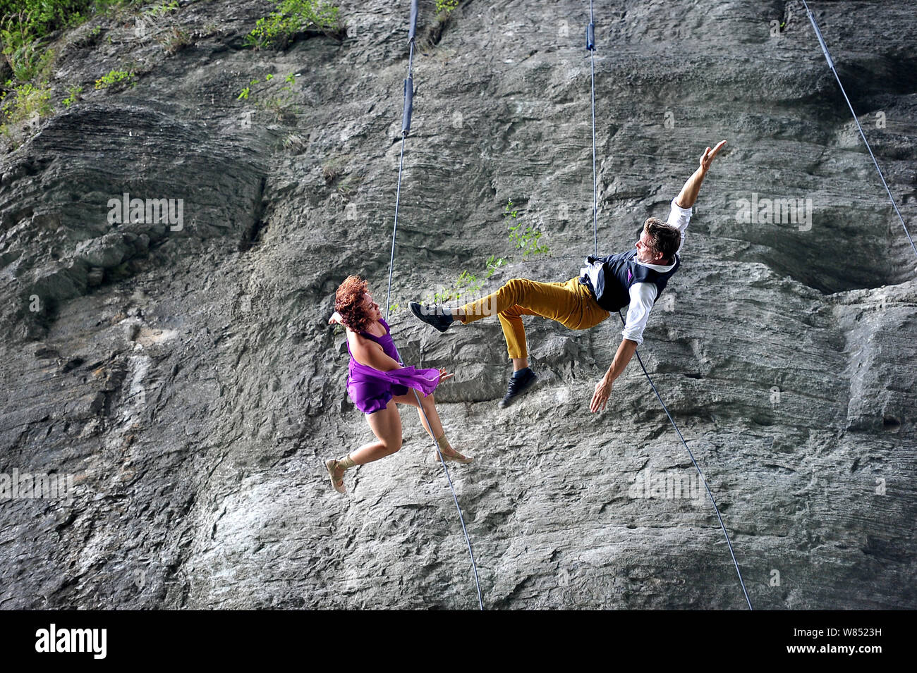 Dancers from American dance troupe Bandaloop perform as they were ...