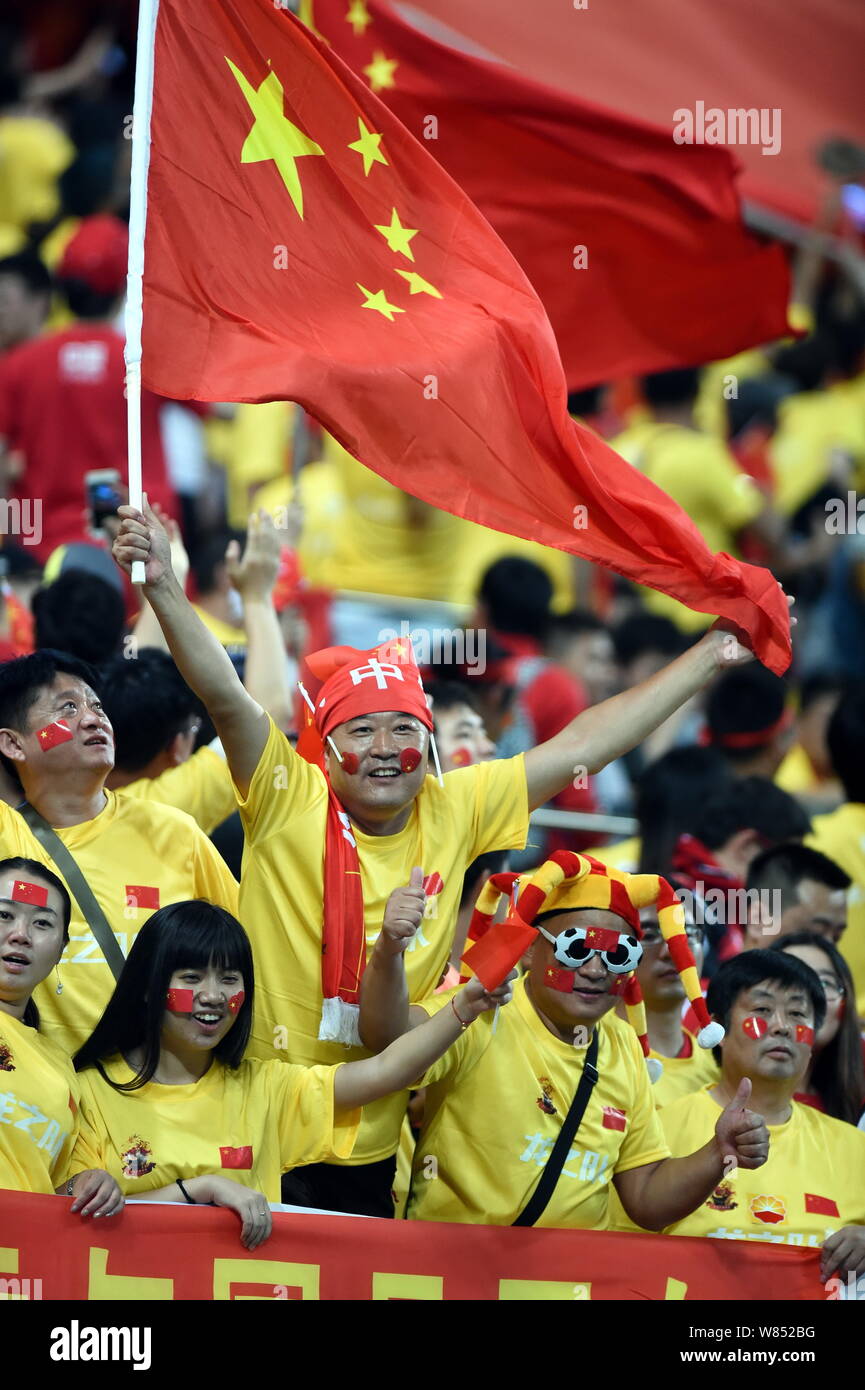 Chinese football fans cheer to show support for the China team during a ...
