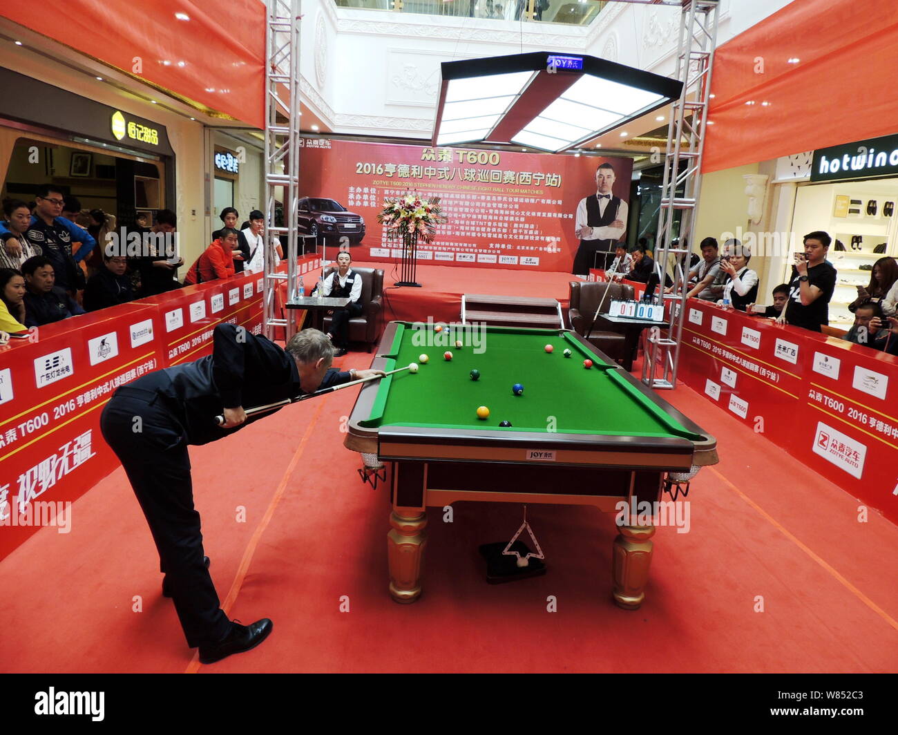Retired Scottish snooker player Stephen Hendry plays a shot against Liu ...