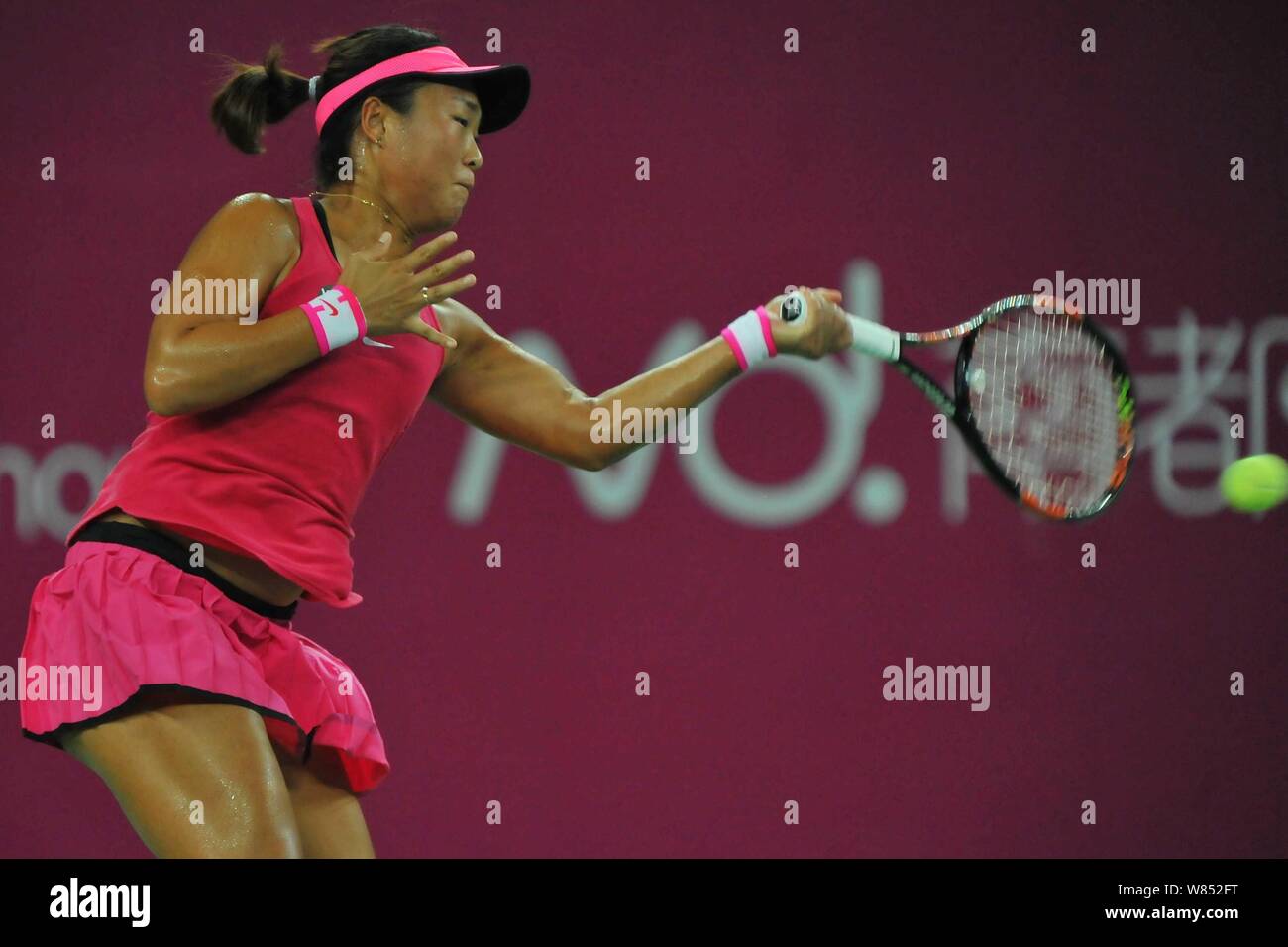 Monica Han Xinyun of China returns a shot to Sara Errani of Italy ...
