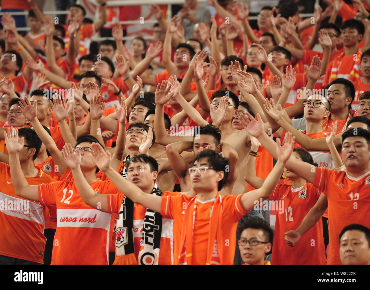 Chinese football fans shout slogans to show support for China's ...