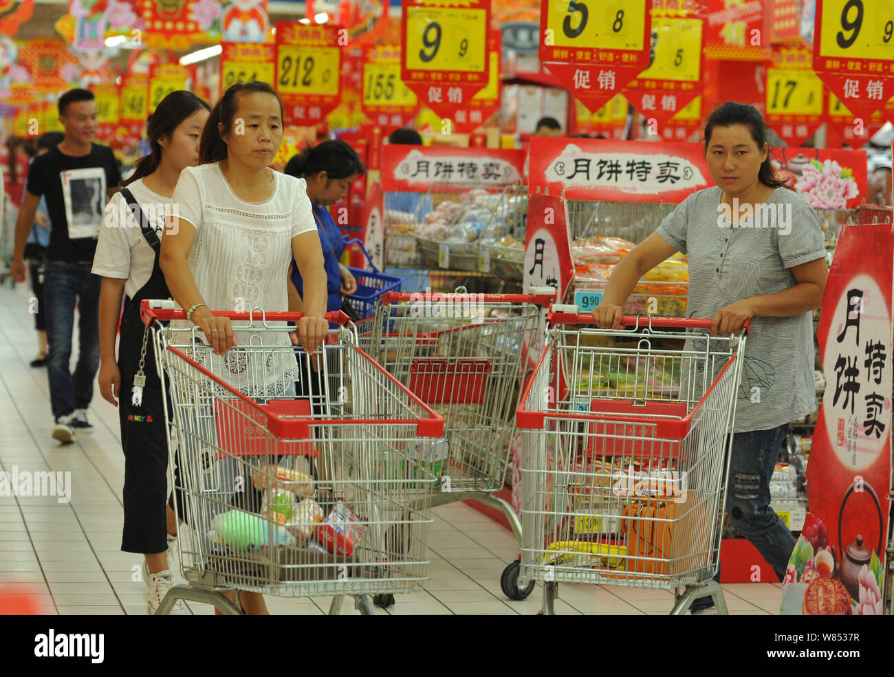 Chinese customers are shopping at a supermarket in Fuyang city, east ...