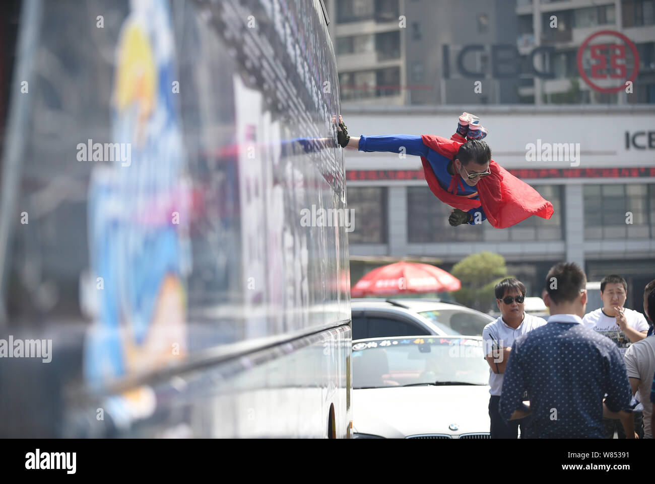 Chinese magician Zhou Jieming dressed like Superman performs a magic ...