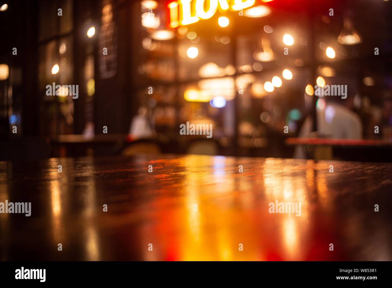 Empty real wood table top with light reflection on scene at restaurant ...