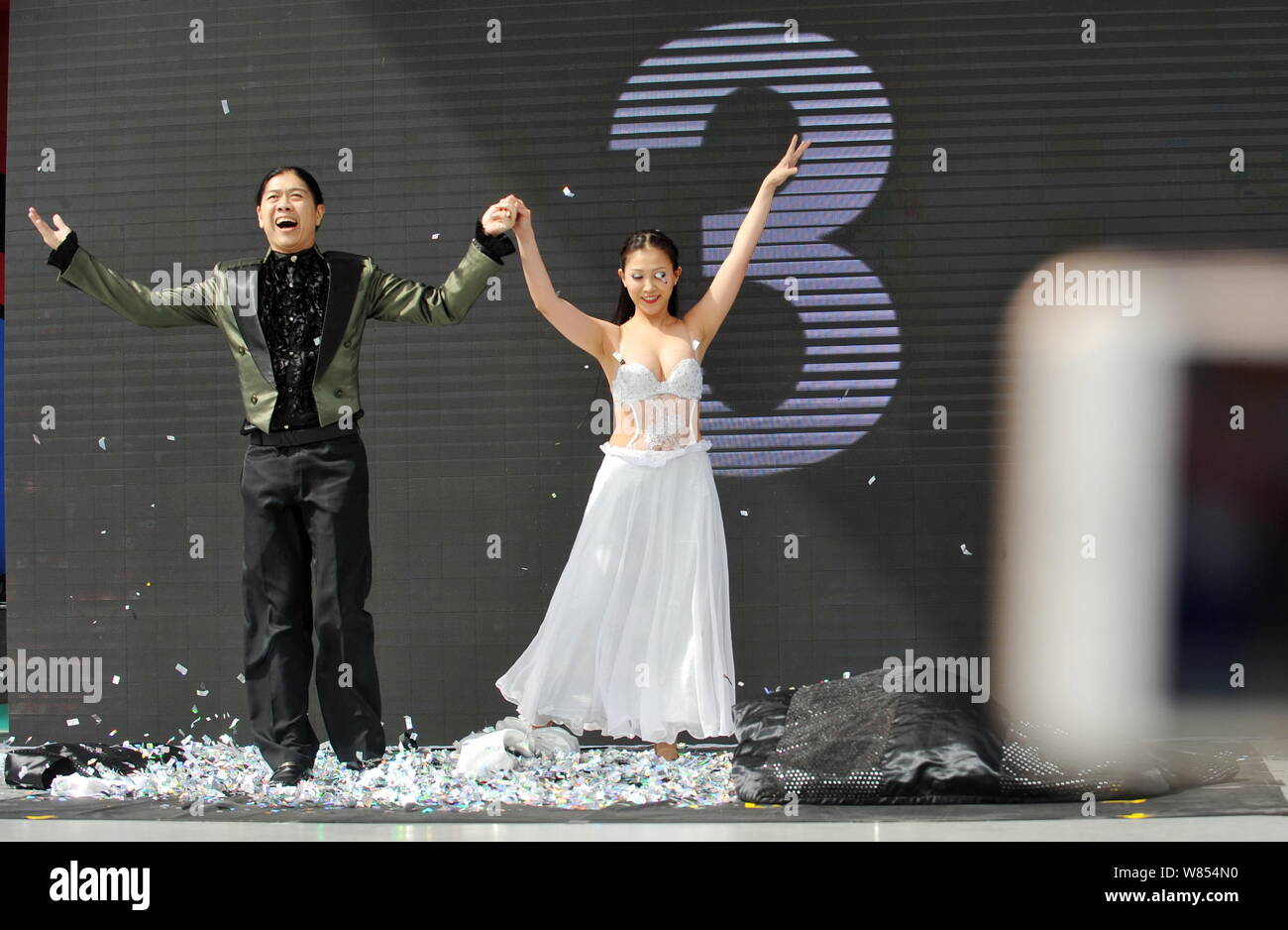Malaysian magician Avery Chin, left, and his partner Sylvia Lim greet ...
