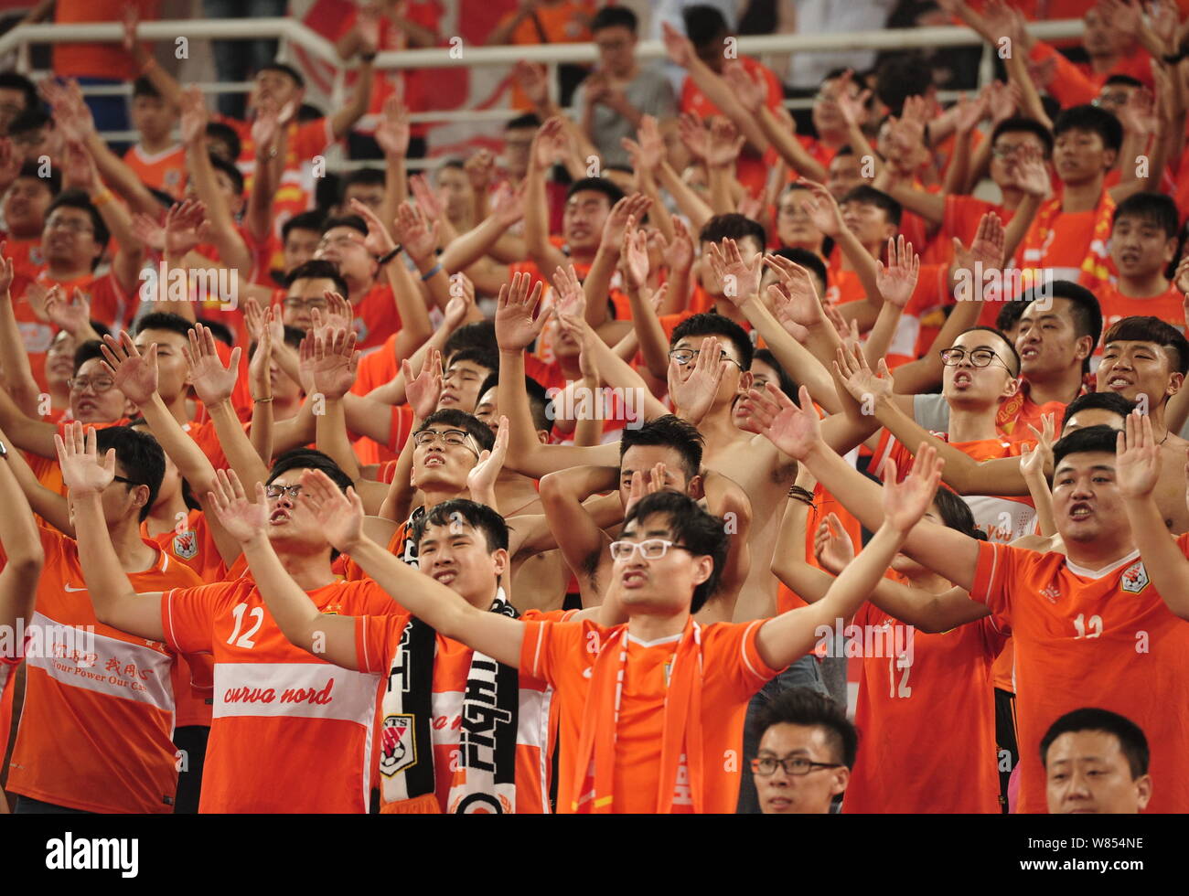 Chinese football fans shout slogans to show support for China's ...