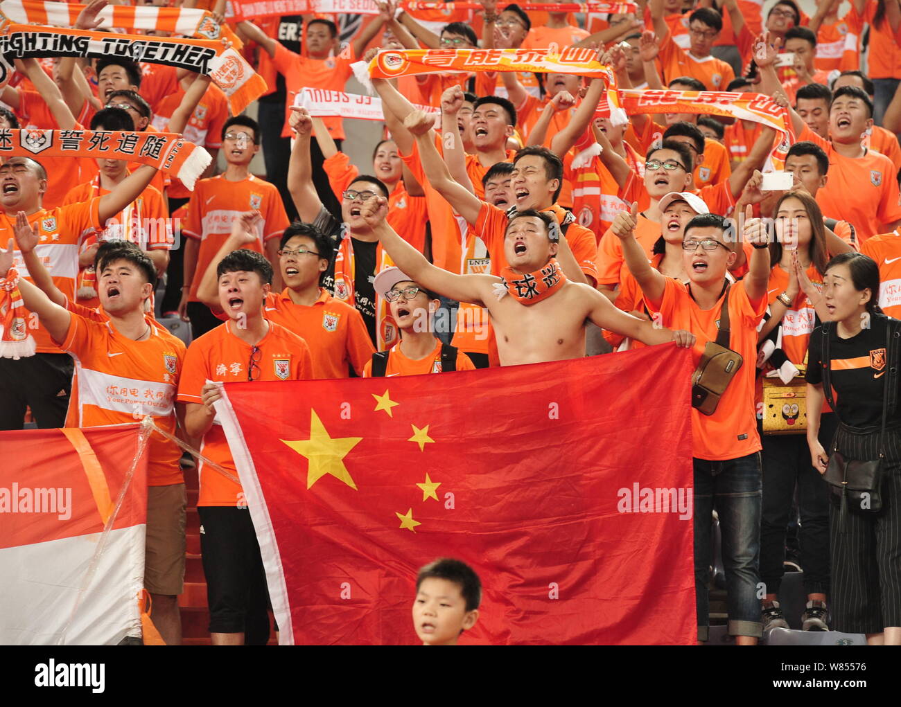 Chinese football fans shout slogans to show support for China's ...