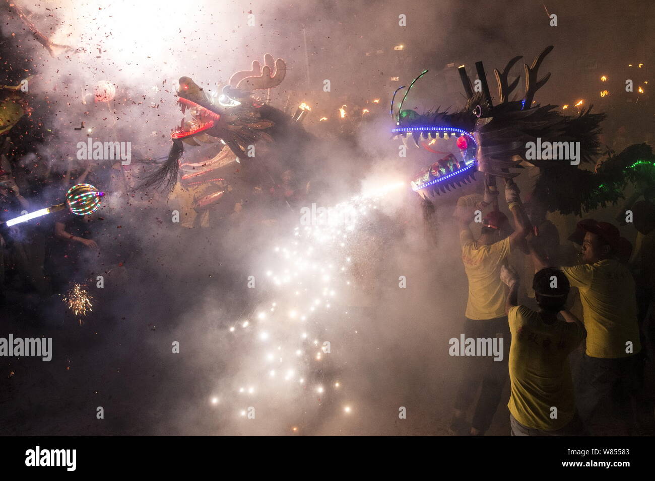 Chinese entertainers perform a fire dragon dance to celebrate the Mid ...