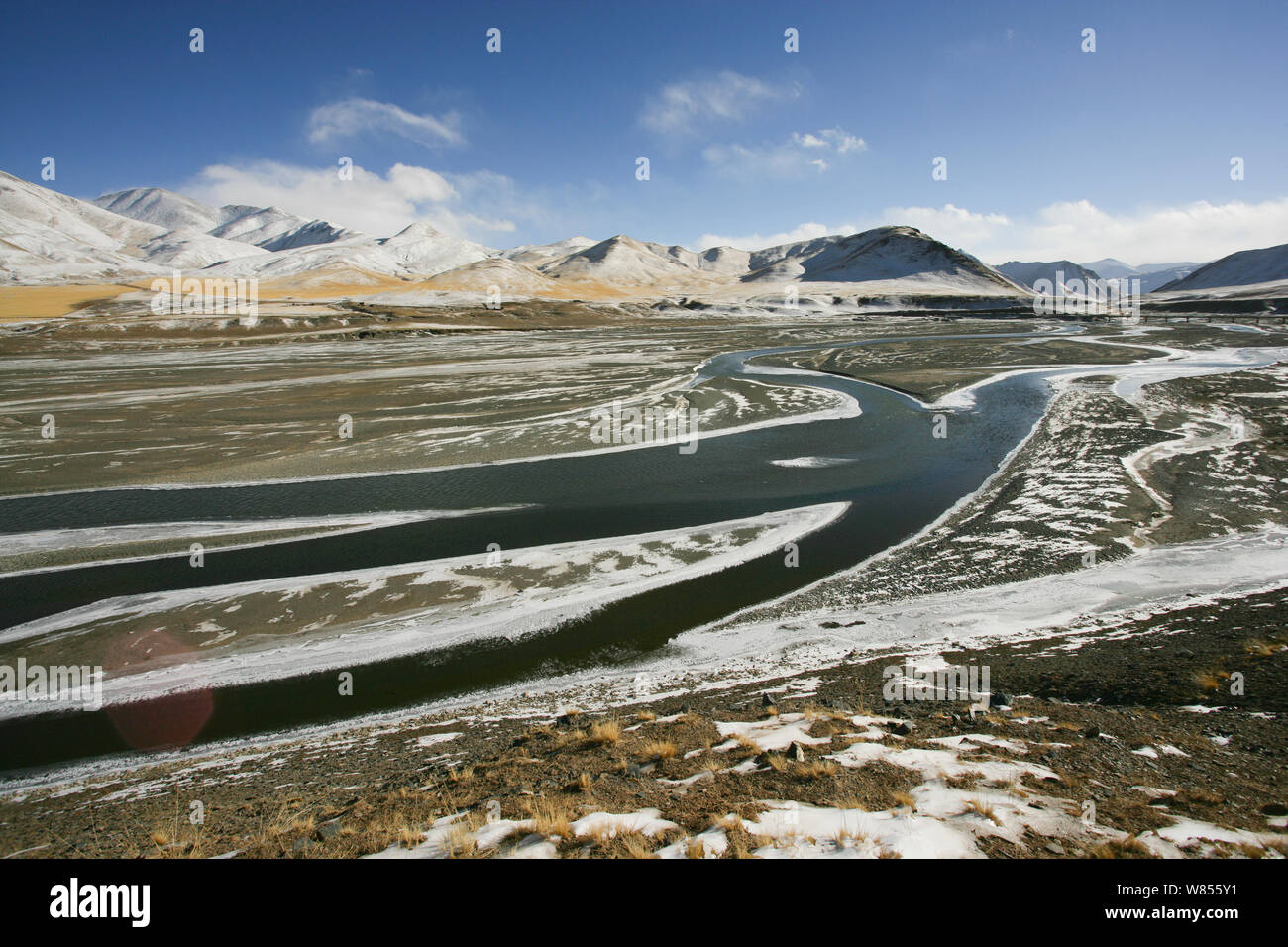 Landscape of Tibetan Plateau, with stream flowing through and mountains ...